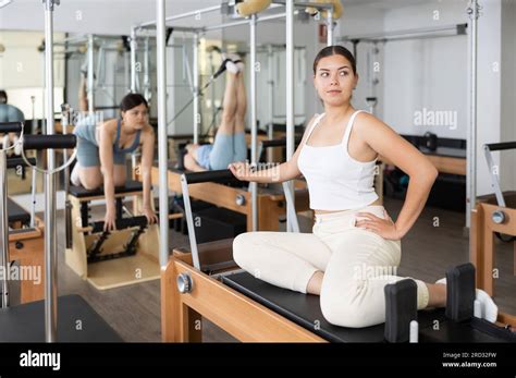 Elderly Woman In Sportswear Training Pilates Performer Bed In Gym Stock