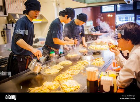 Chef Cooking Okonomiyaki In A Restaurant Of Okonomi Mura Hiroshima