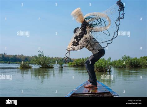 Tribal Man Fishing With Net Along The Mekong River In Cambodia Stock Photo Alamy