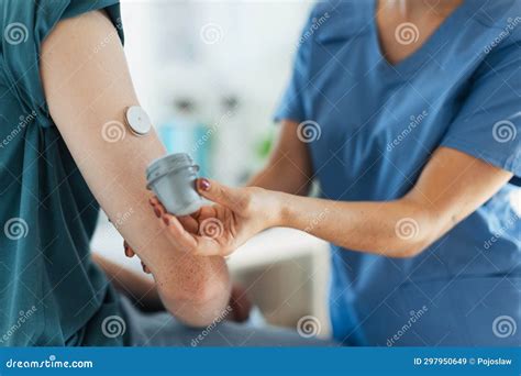 Nurse Applying A Continuous Glucose Monitor Sensor On Arm Of A Diabetic Teenager Cgm Device