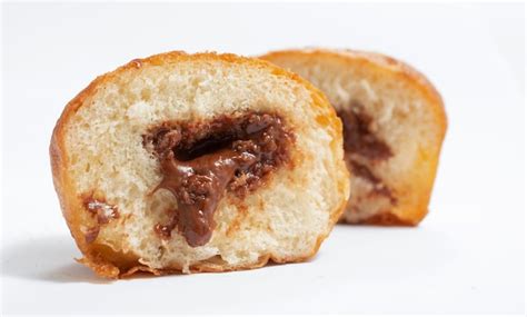 Premium Photo Small Round Donuts With Chocolate Filling On White