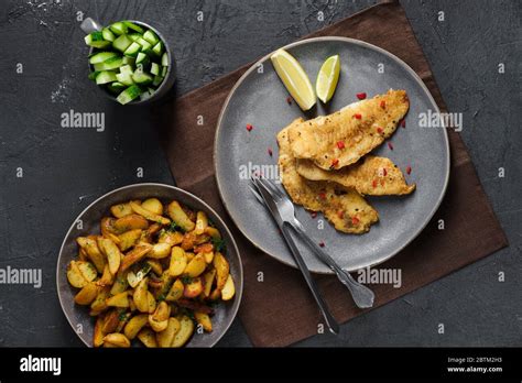 Fried Breaded Hake Fillet With Spice And Roasted Potato Wedges Stock