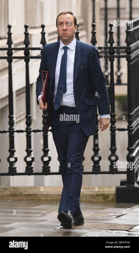 Health And Social Care Secretary Matt Hancock Looks Up As He Arrives In