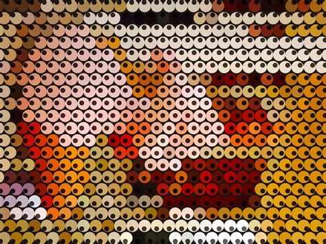 Premium Photo A Colorful Wall Of Spools Of Paper With A Red Background