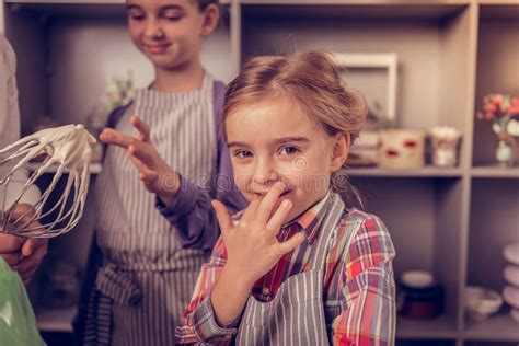 Cheerful Pretty Girl Licking Her Fingers With Cream Stock Photo Image Of Kitchen Gourmet