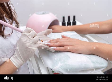 A Woman In Beauty Center Performing A Nail Service And Beautification Of Hands And Nails Stock
