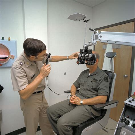 Major Leonard Langeliers Performs An Eye Examination On Chief Warrant 4