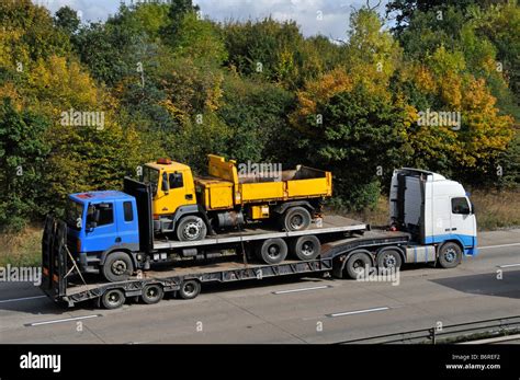 M25 Motorway Low Loader Articulated Lorry And Trailer Loaded With Two