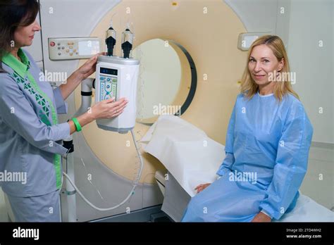 Radiographer Involved In Preparation Of Female Patient For Contrast