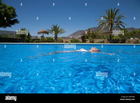 White Bikini Woman Lying On The Water In A Big Blue Pool Stock Photo Alamy