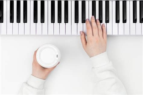 Premium Photo Women039s Hands Play The Synthesizer With A Cup Of