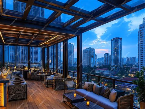 A Rooftop Lounge With Panoramic City Views Featuring Comfortable Seating And Warm Lighting