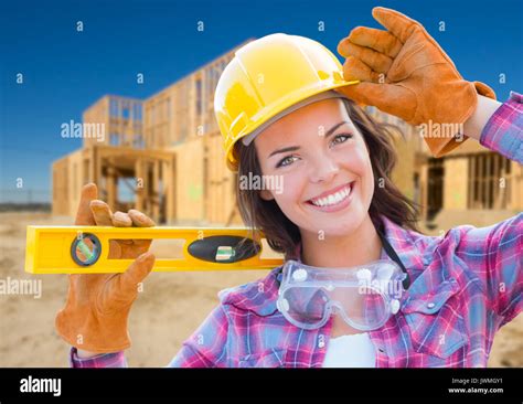 Female Construction Worker Holding Level Wearing Gloves Hard Hat And