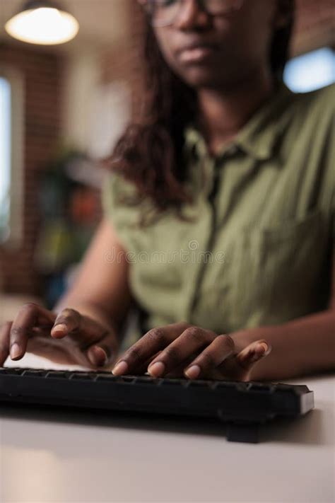 Closeup Of African American Woman Programmer Writing Code On Computer