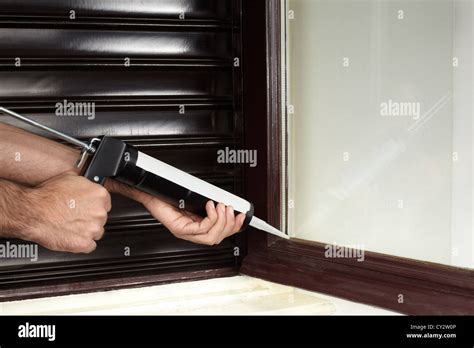 Applying Silicone Sealant With Caulking Gun Stock Photo Alamy