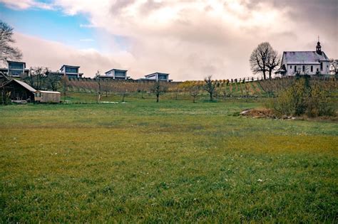 Premium Photo Grassy Field Against Cloudy Sky