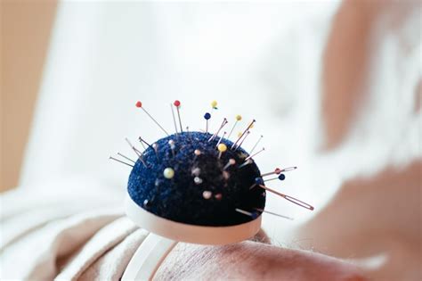 Premium Photo Cropped Image Of Hand With Pin Cushion