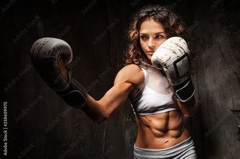 Sport Young Woman Wearing Boxing Gloves Posing In Combat Stance Looking