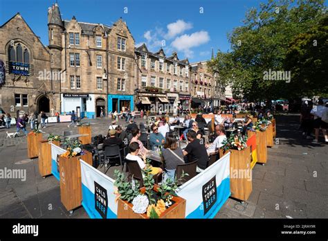 Tourists Eating In Outdoor Restaurant In The Grassmarket In Edinburgh