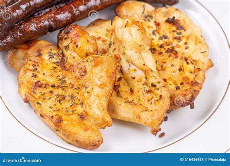 Delicious Chicken Breasts Fried And Served With Fried Sausages On The