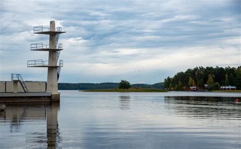 Diving Board Platform For Dive In The Lake Cloudy Sky Copy Space For