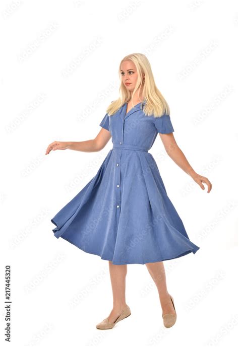 Full Length Portrait Of Blonde Girl Wearing Blue Dress Standing Pose
