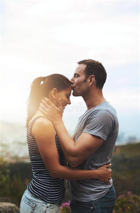 Loving To Their Hearts Content A Young Man Affectionately Kissing His
