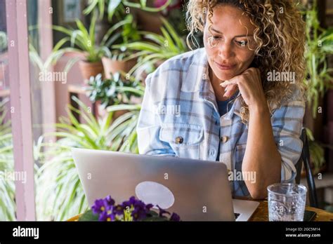 Mature Woman Work At Computer Sitting On Home Office Desktop And Smiling Looking The Laptop