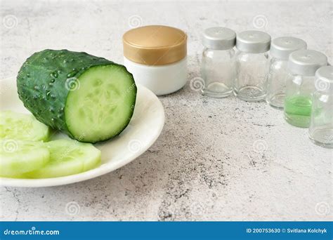 Cucumber Cosmetic Cream Face And Hand On Silver Background Skin And