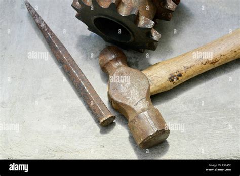 Close Up Shot Of An Old Rusty Ball Peen Hammer Chisel And Metal Stock