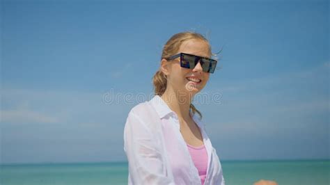 Young Women Play In The Sea On Their Summer Vacation And They Smile And