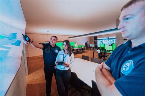 Group Of Security Operators Working In A Data System Control Room