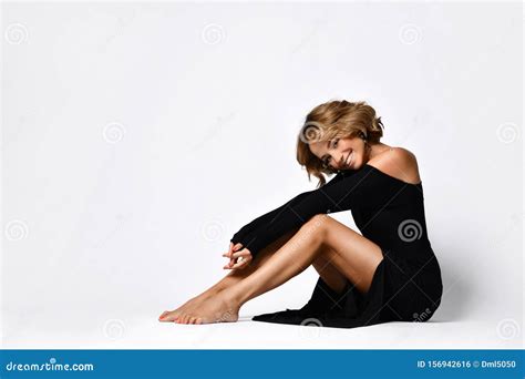 Cheerful And Charming Woman Actress With Curly Hair Sitting On The