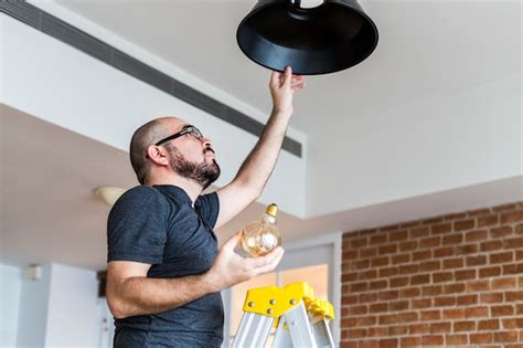 Free Photo Man Changing Light Bulb