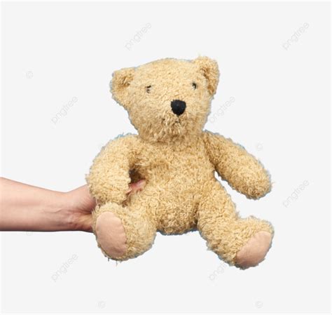 On A Blue A Small Brown Toy Teddy Bear Is Held By A Female Hand Single
