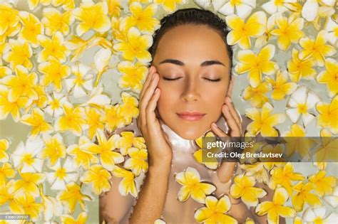 Glamour Closeup Woman Portrait In Spa Bath Full Of Uellow Flowers