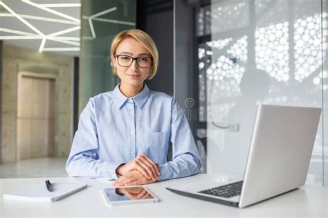 Portrait Of A Successful Businesswoman Sitting At A Desk In The Office