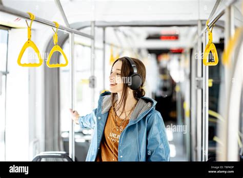 Young Stylish Woman With Headphones While Moving In The Modern Tram