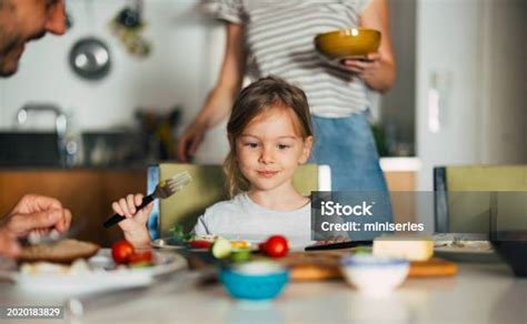 클로즈업 사진 그녀의 인식할 수 없는 가족과 함께 아침 식사를 하는 어린 소녀 아이에 대한 스톡 사진 및 기타 이미지 아이 먹기 가족 Istock