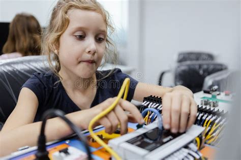 Girl Caucasoid Education Electronic Robotic Arm On Table At Class Room