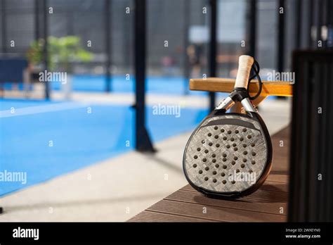 Paddle Tennis Paddel Racket And Ball In Front Of An Outdoor Court