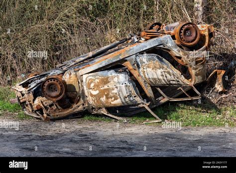 Wrecked Car Turned Upside Down On The Side Of The Road After Being