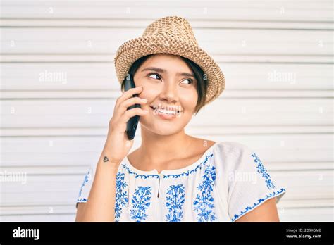 Young Latin Tourist Girl On Vacation Smiling Happy Talking On The