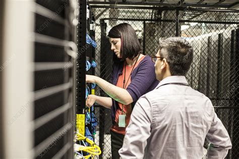 Technicians Working On Cables In A Server Farm Stock Image F0218770 Science Photo Library