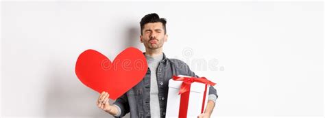 Sad And Heartbroken Man Being Rejected Crying And Holding Red Heart