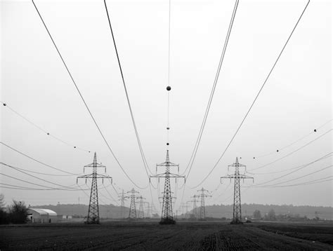 Premium Photo Electricity Pylons On Field Against Clear Sky