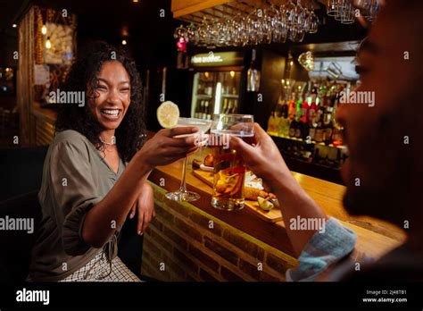 Two Friends Having Drinks At The Bar Cheers Stock Photo Alamy