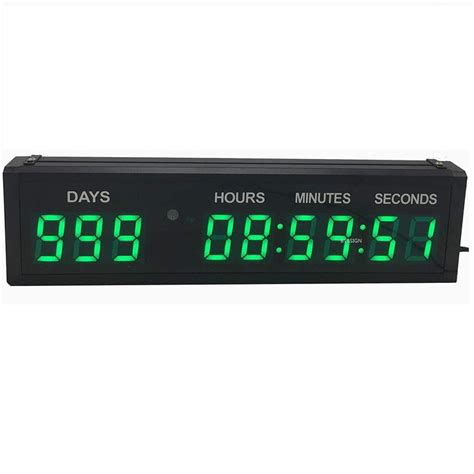 An Alarm Clock With Green Numbers On The Front And Back Displays Hours