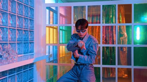 Asian Performer Moving Freestyle Dance While Looking At Camera