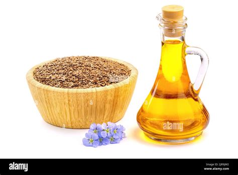 Blue Flax Flowers And Raw Flax Seeds Isolated On White Background